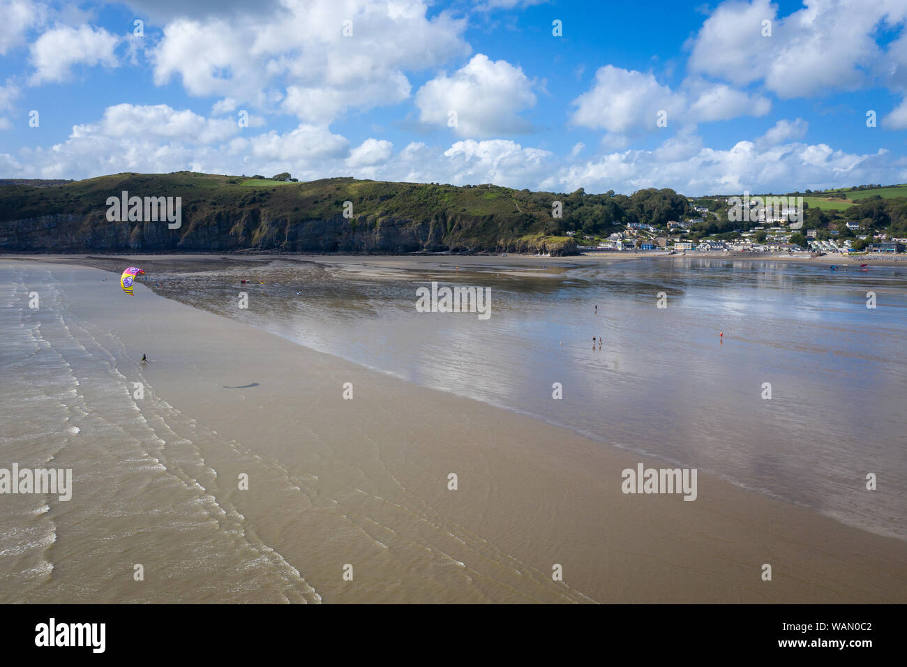 Aerial view of person kite surfing on the water of pendine sands beach ...