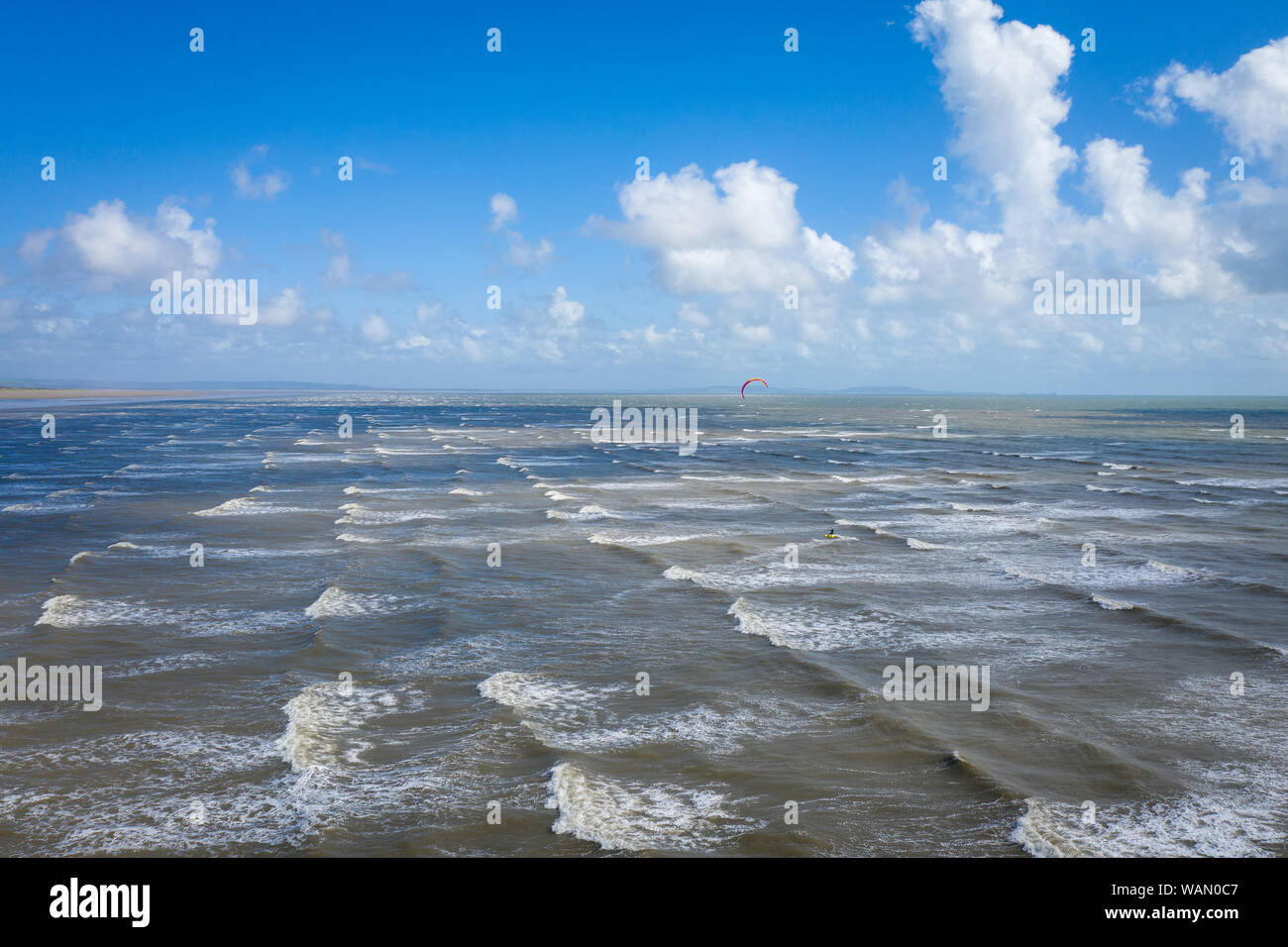 Aerial view of person kite surfing on the water of pendine sands beach ...