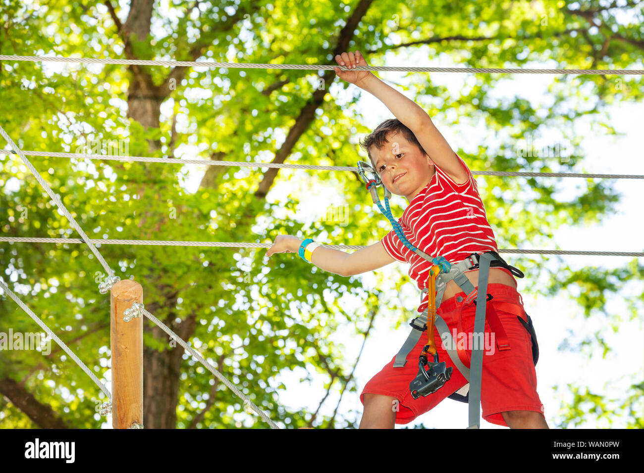 Portrait of a boy at rope climbing adventure park Stock Photo - Alamy