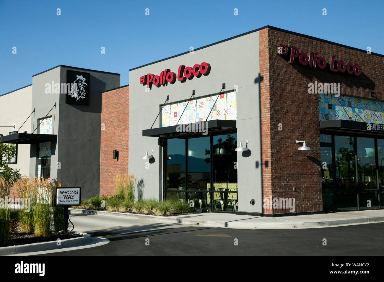 A logo sign outside of a El Pollo Loco fast food restaurant location in ...