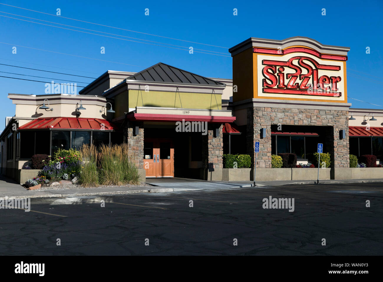 A logo sign outside of a Sizzler restaurant location in Orem, Utah on ...