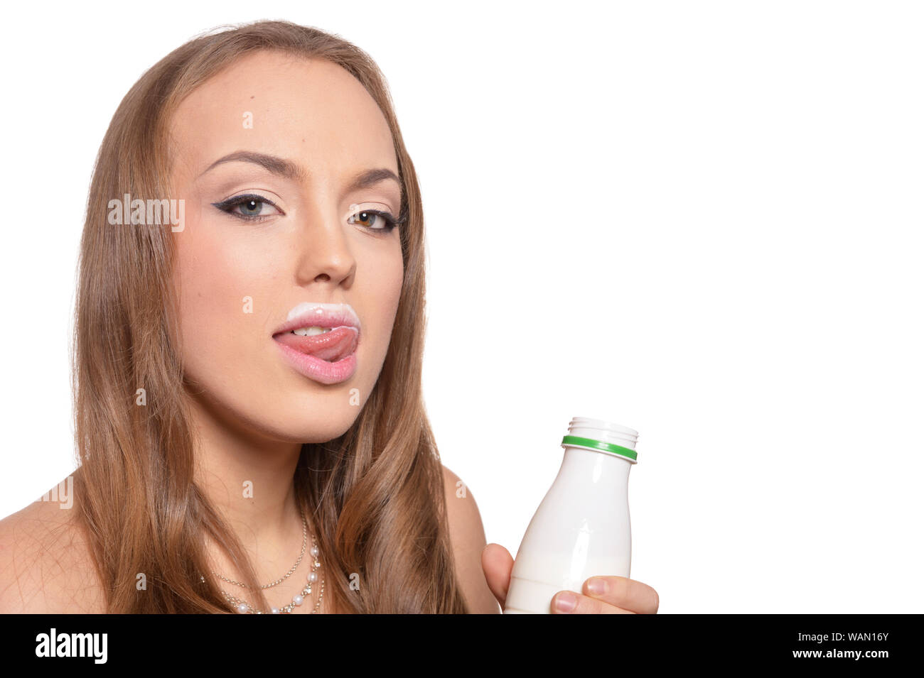 Portrait of a beautiful young woman with milk isolated on white ...