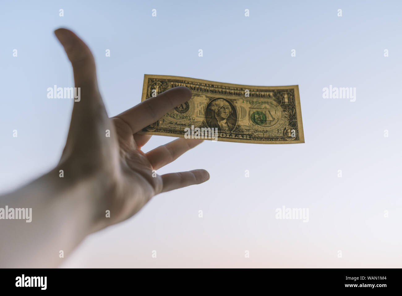 Hand giving dollar note hi-res stock photography and images - Alamy