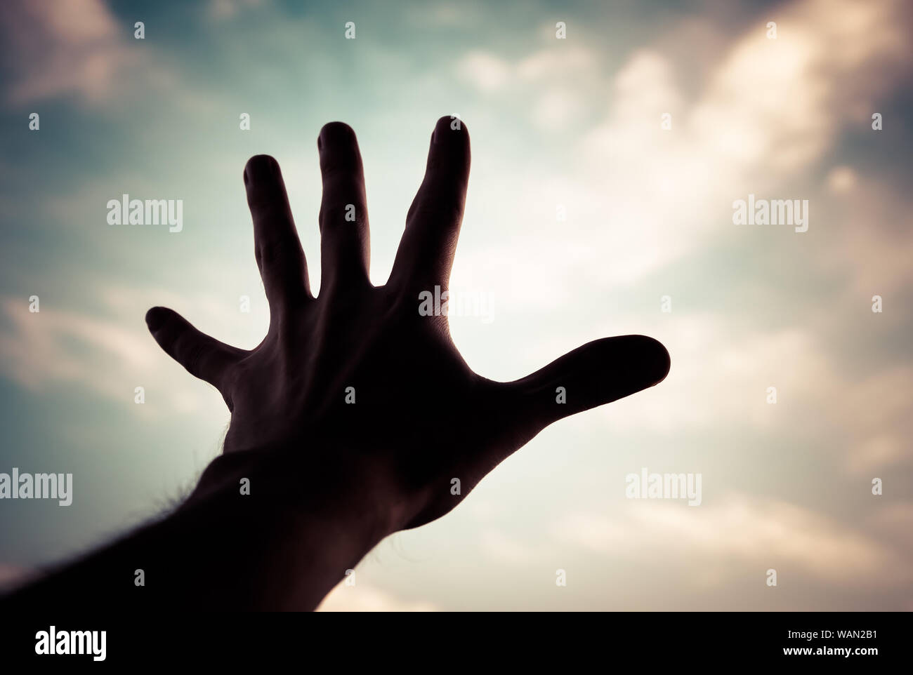 Hand of a man reaching to towards sky. Color toned image Stock Photo ...