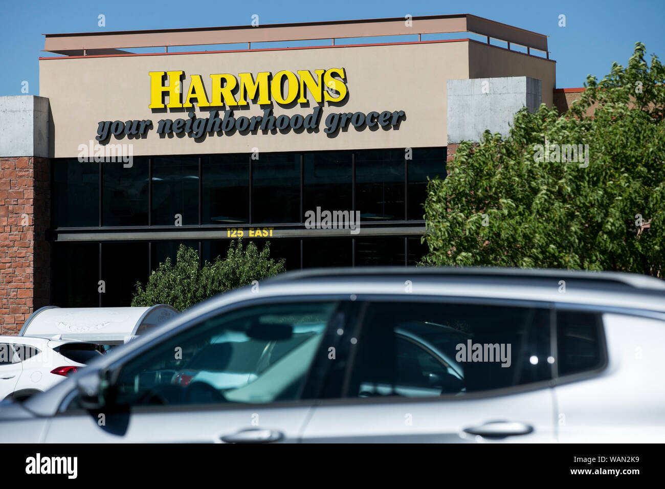 A logo sign outside of a Harmons retail grocery store location in Lehi, Utah on July 30, 2019 ...