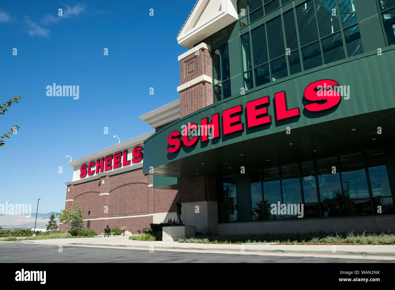A logo sign outside of a SCHEELS retail store location in Sandy, Utah ...