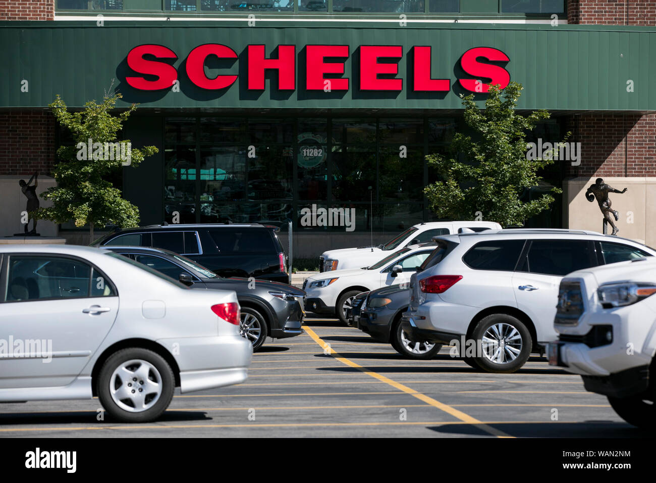 A logo sign outside of a SCHEELS retail store location in Sandy, Utah ...