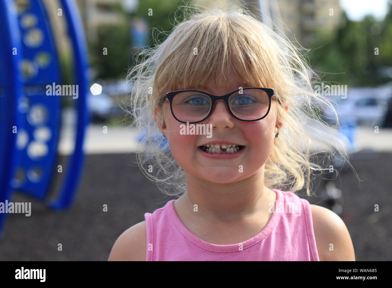 Little girl smiling outside showing her missing middle tooth Stock ...