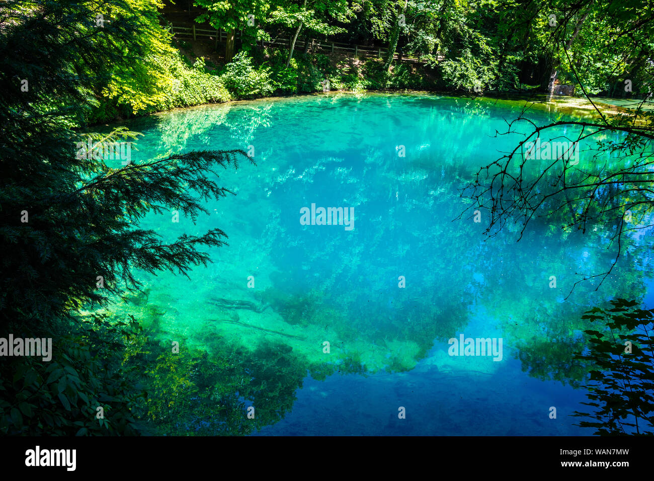 Germany, Blue glassy waters of source blue pot (blautopf) in blaubeuren ...