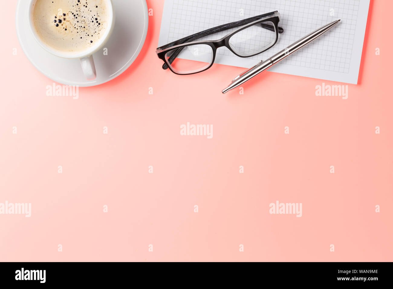 Office pink workplace backdrop with coffee cup and supplies. Flat lay ...
