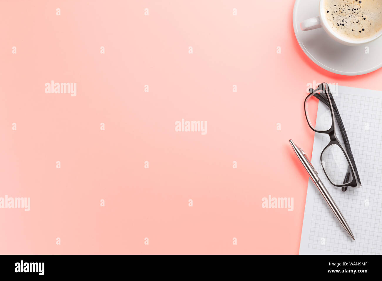 Office pink workplace backdrop with coffee cup and supplies. Flat lay ...