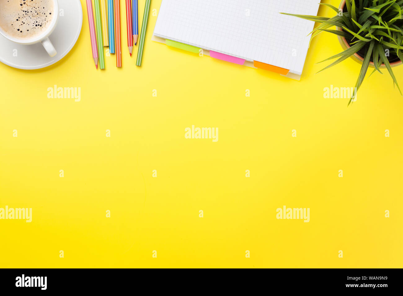 Office yellow workplace backdrop with coffee cup and supplies. Flat lay ...