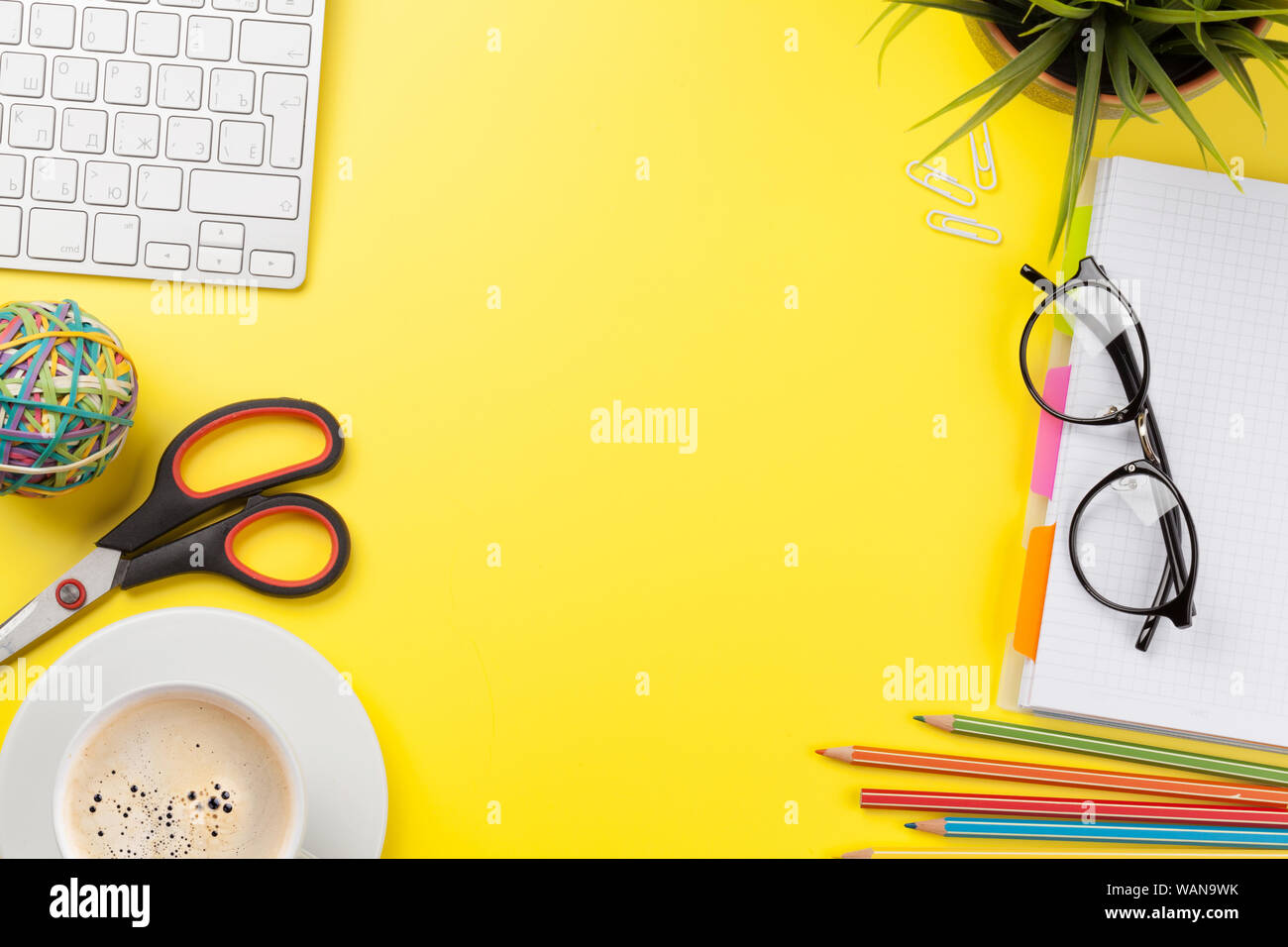Office yellow workplace backdrop with coffee cup, supplies and computer ...