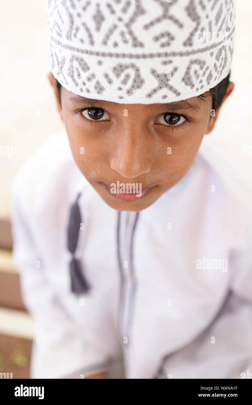 Young boy wearing colorful embroidered cap at Sinaw market, Oman Stock ...