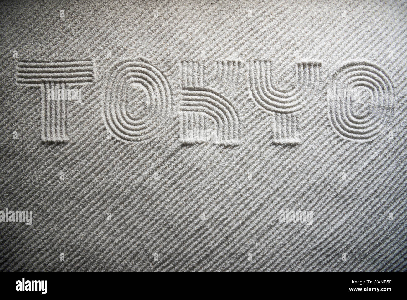 Japanese Zen garden raked with the word TOKYO in capital letters in ...