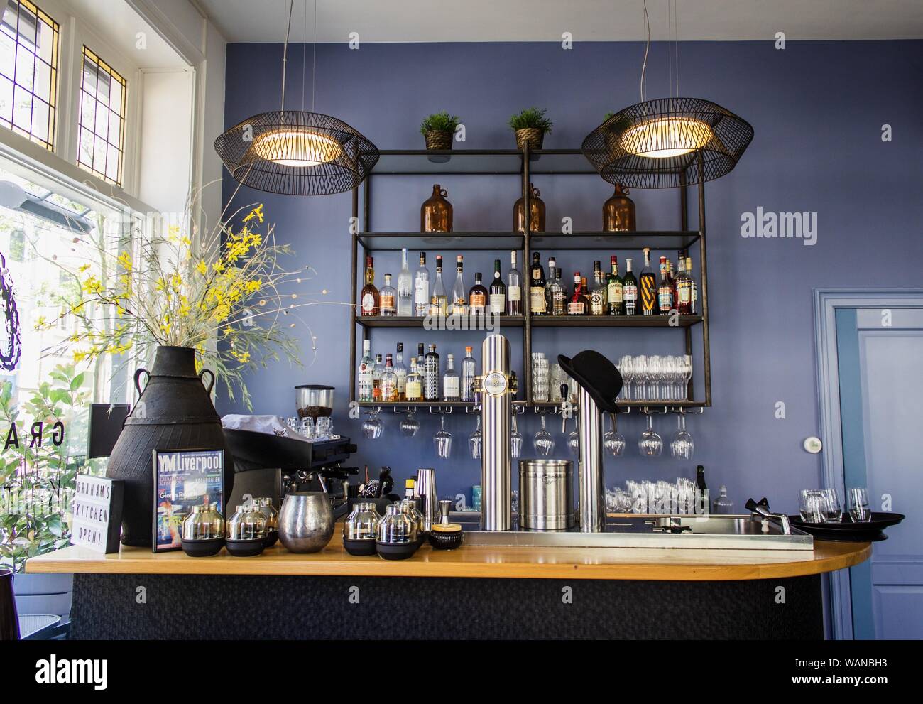 Interior shot of a bar with different drink bottles on a shelf with ...