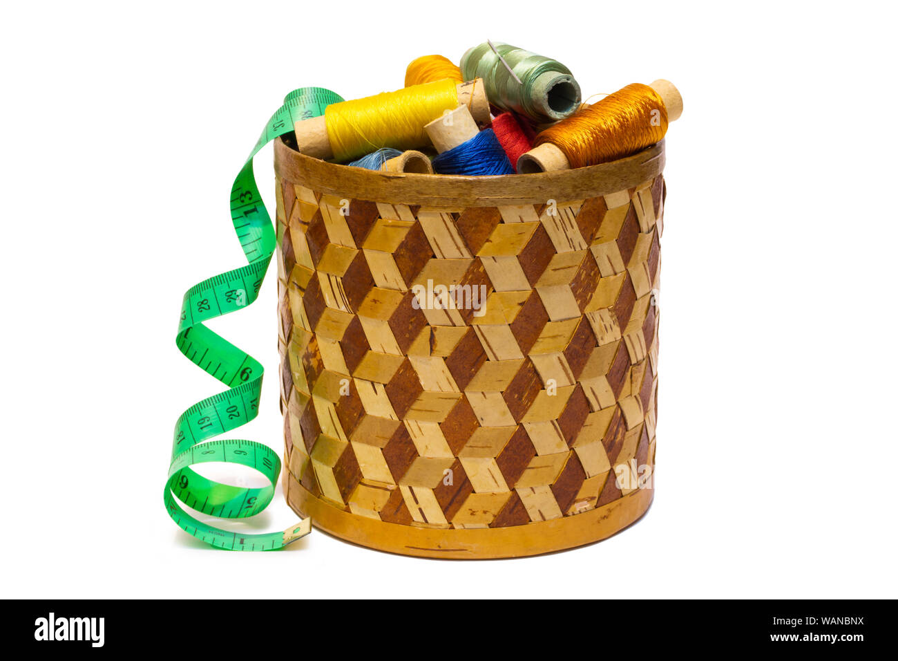 braided manually birchbark cylindrical box with spools of colored ...