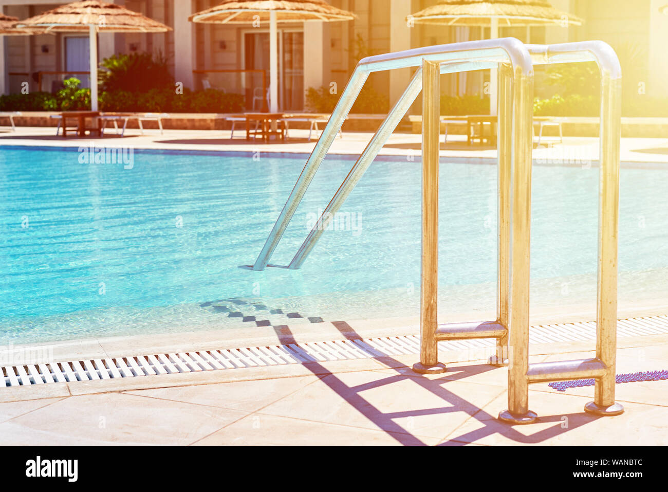 Background of water in blue swimming pool, water surface with sun ...