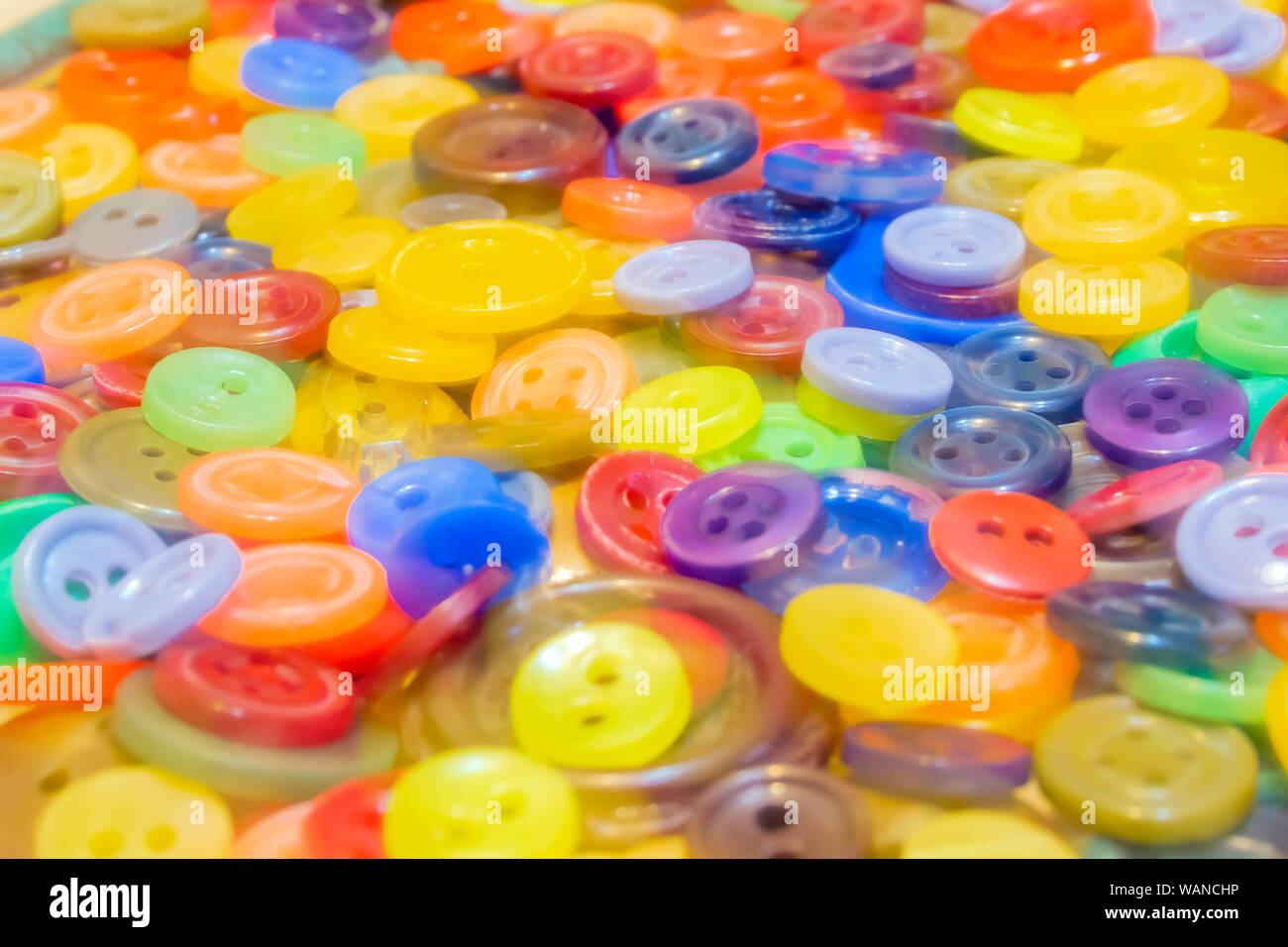 blurred background - randomly scattered multicolored sew-through ...