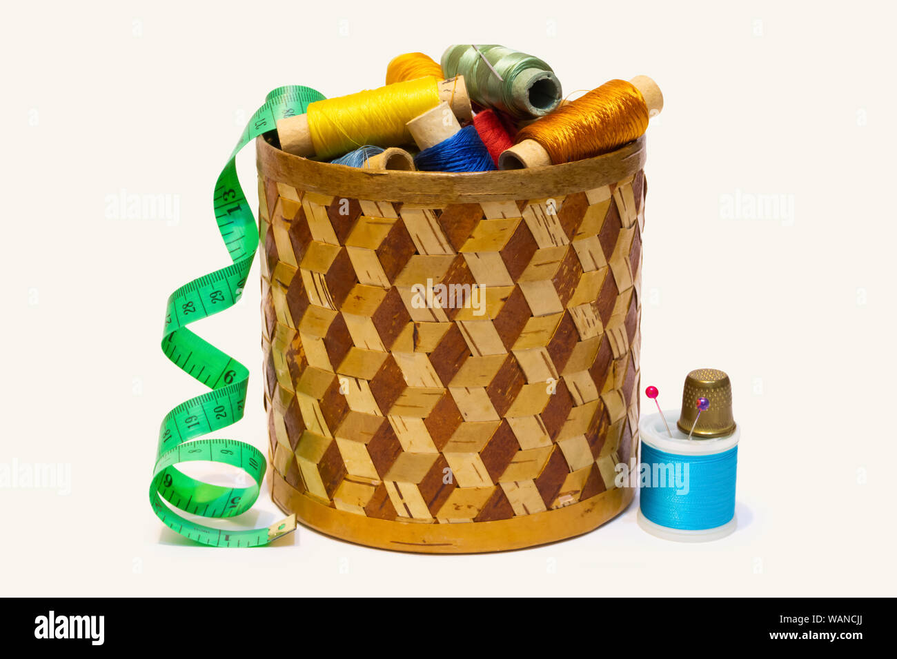 braided manually birchbark cylindrical box with spools of colored ...
