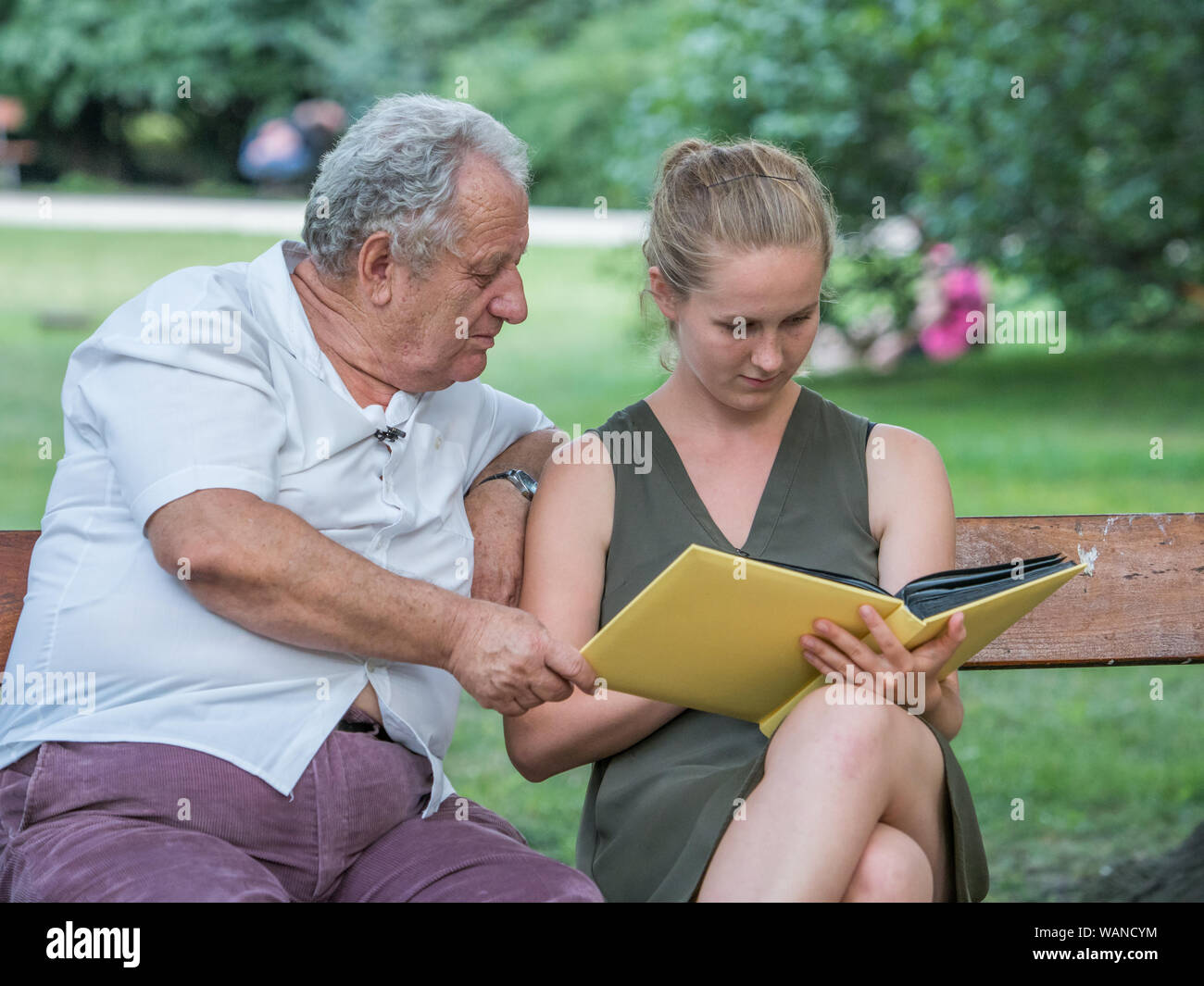 Grandpa and his granddaughter are talking and spend time together. They ...