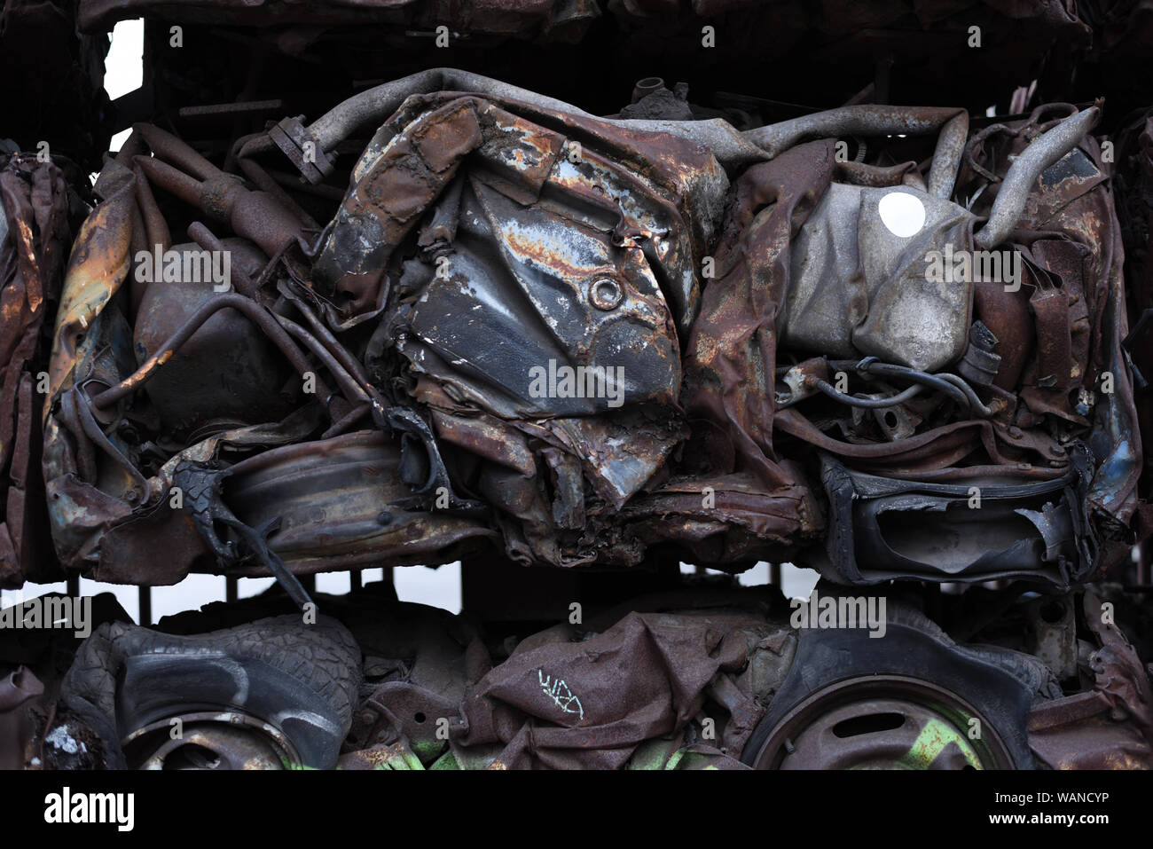 Rusty old crushed cars (automobiles) with auto wheels, tyres (tires ...