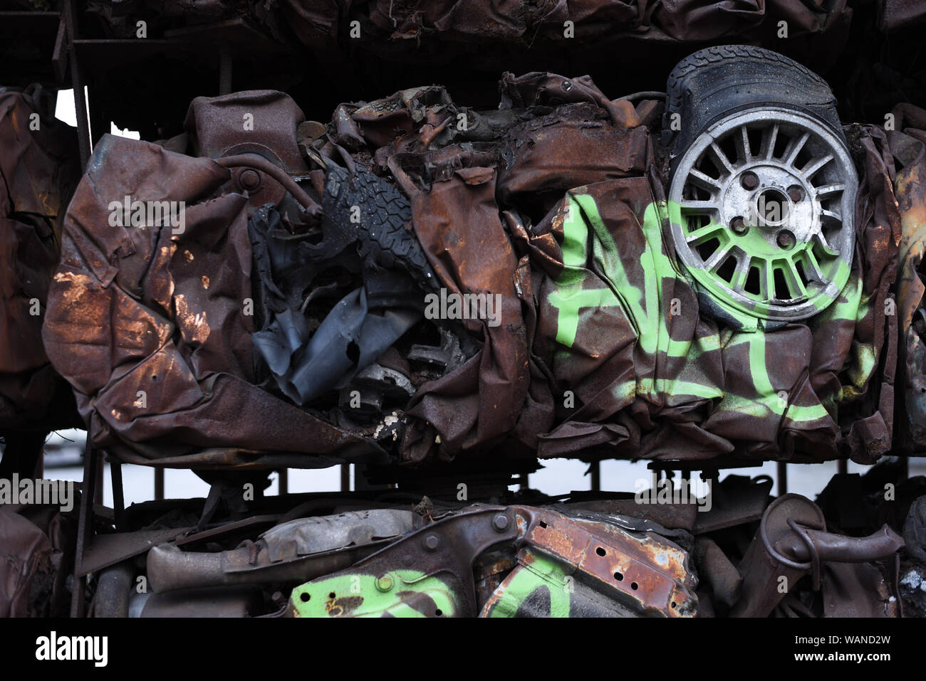 Rusty old crushed cars (automobiles) with auto wheels, tyres (tires ...