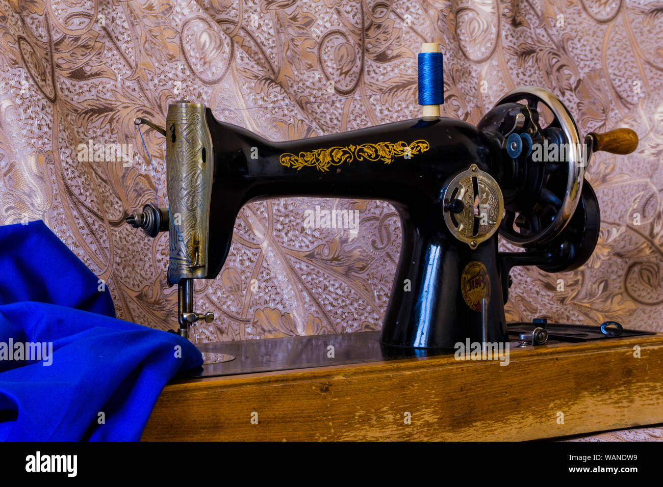 still life with antique sewing machine and and bright blue fabric Stock ...