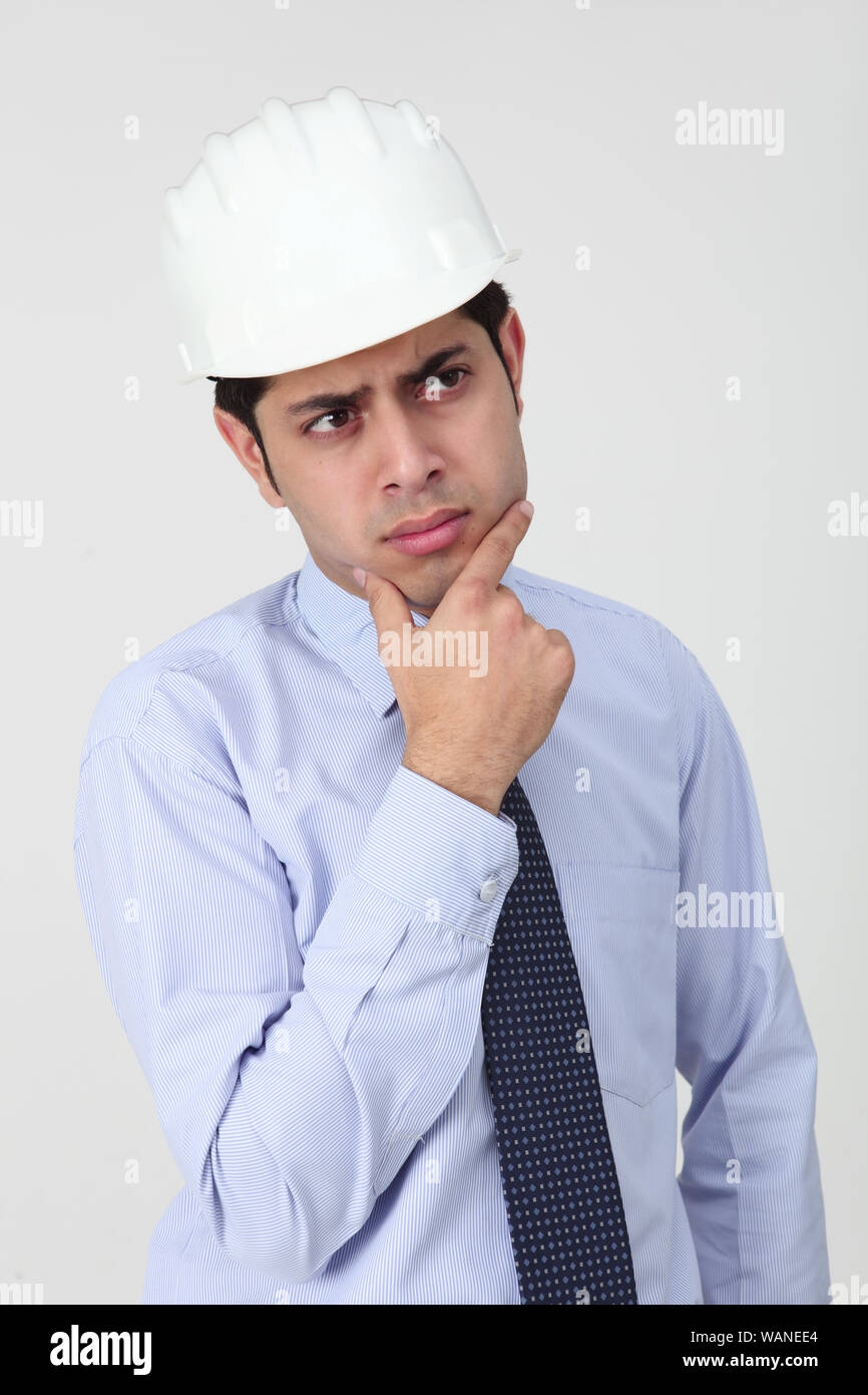 Architect thinking with his hand on chin Stock Photo - Alamy