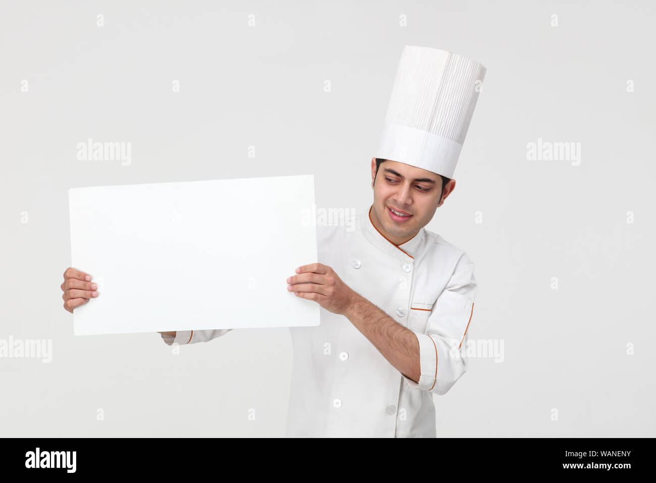 Chef showing a blank placard Stock Photo - Alamy