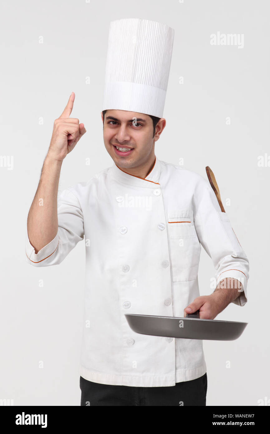 Chef preparing food and pointing upward Stock Photo - Alamy