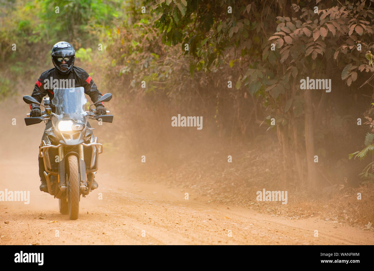 Man riding his ADV motorbike on rural dirt road in Cambodia Stock Photo ...