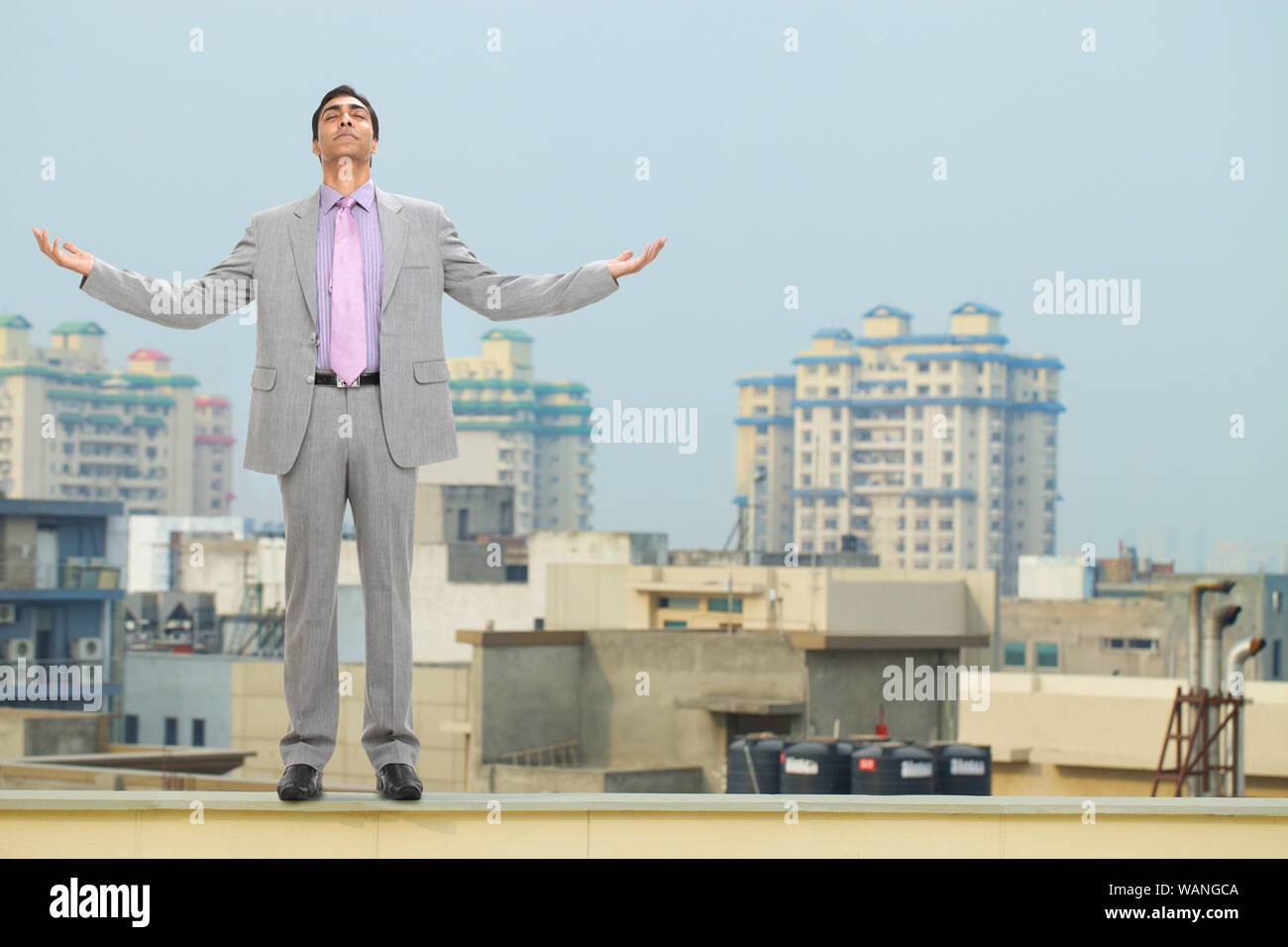 Businessman standing with his arm outstretched Stock Photo - Alamy