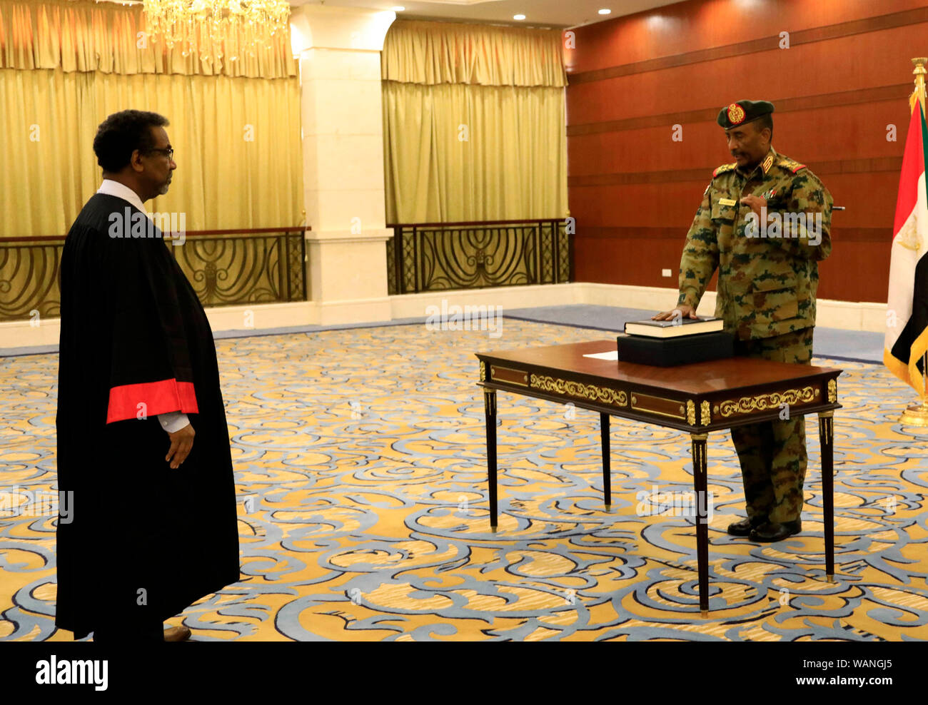 Khartoum, Sudan. 21st Aug, 2019. Abdel Fattah al-Burhan (R) takes the constitutional oath before ...
