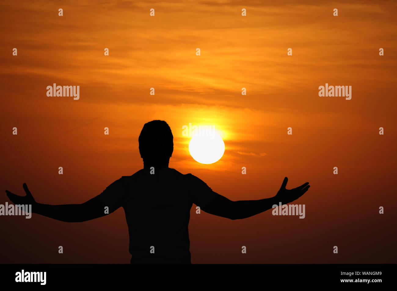Silhouette of a man with his arms outstretched Stock Photo - Alamy