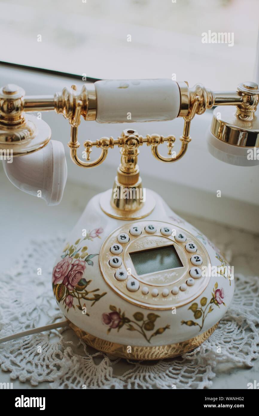 Vertical selective closeup shot of a luxurious white and gold retro ...