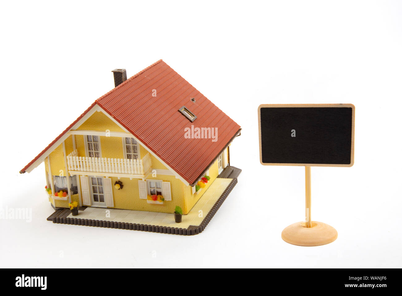 Toy House and little Blackboard Sign on white Background Stock Photo ...