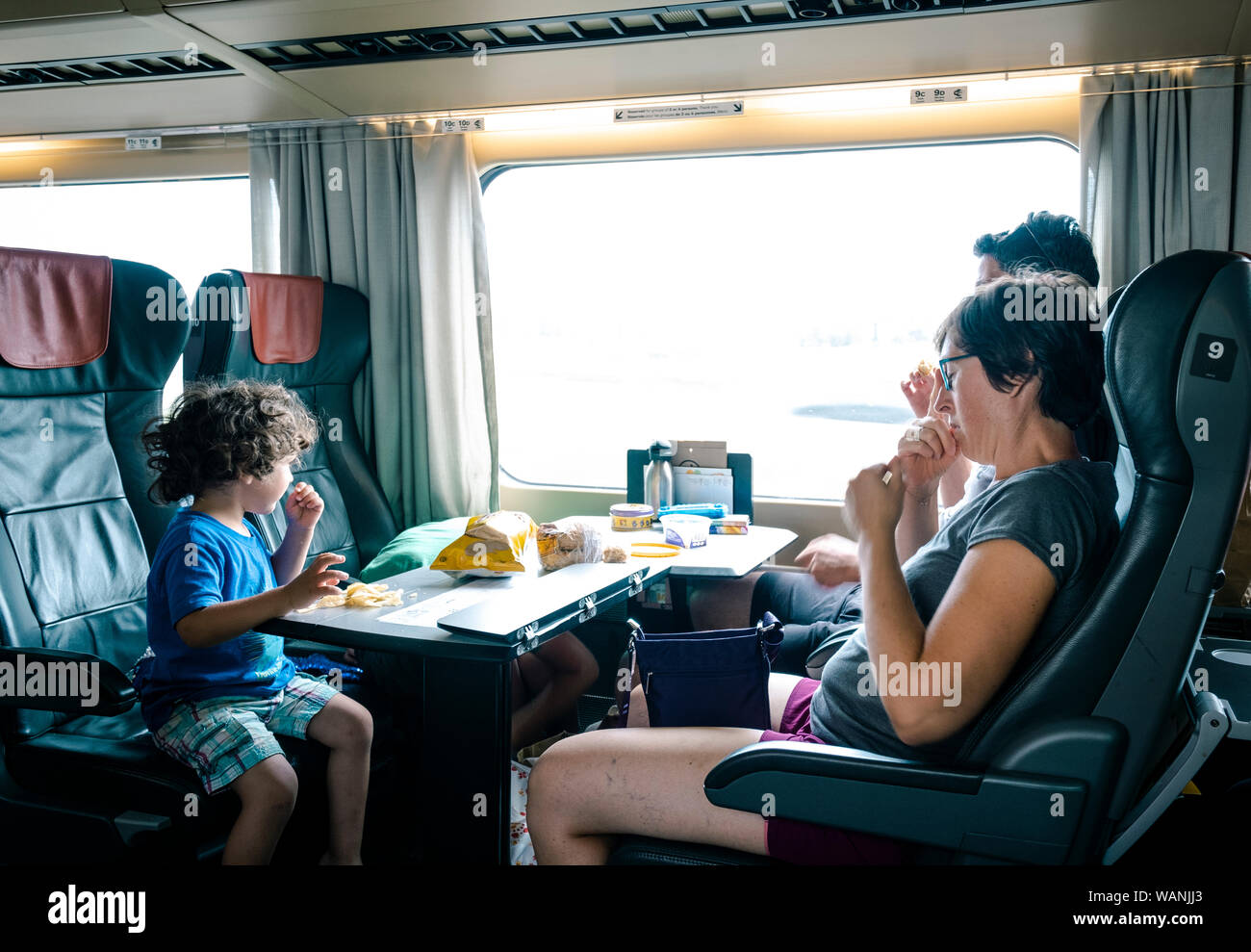Family Relaxing On Train Journey Stock Photo - Alamy