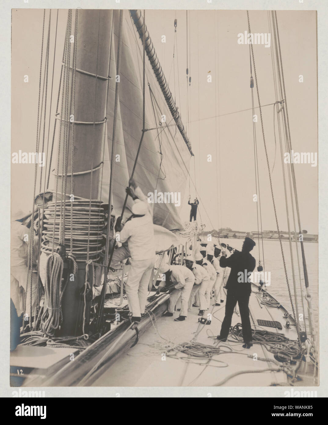 Crew hoisting mainsail on the yacht Reliance, winner of 1903 America's ...