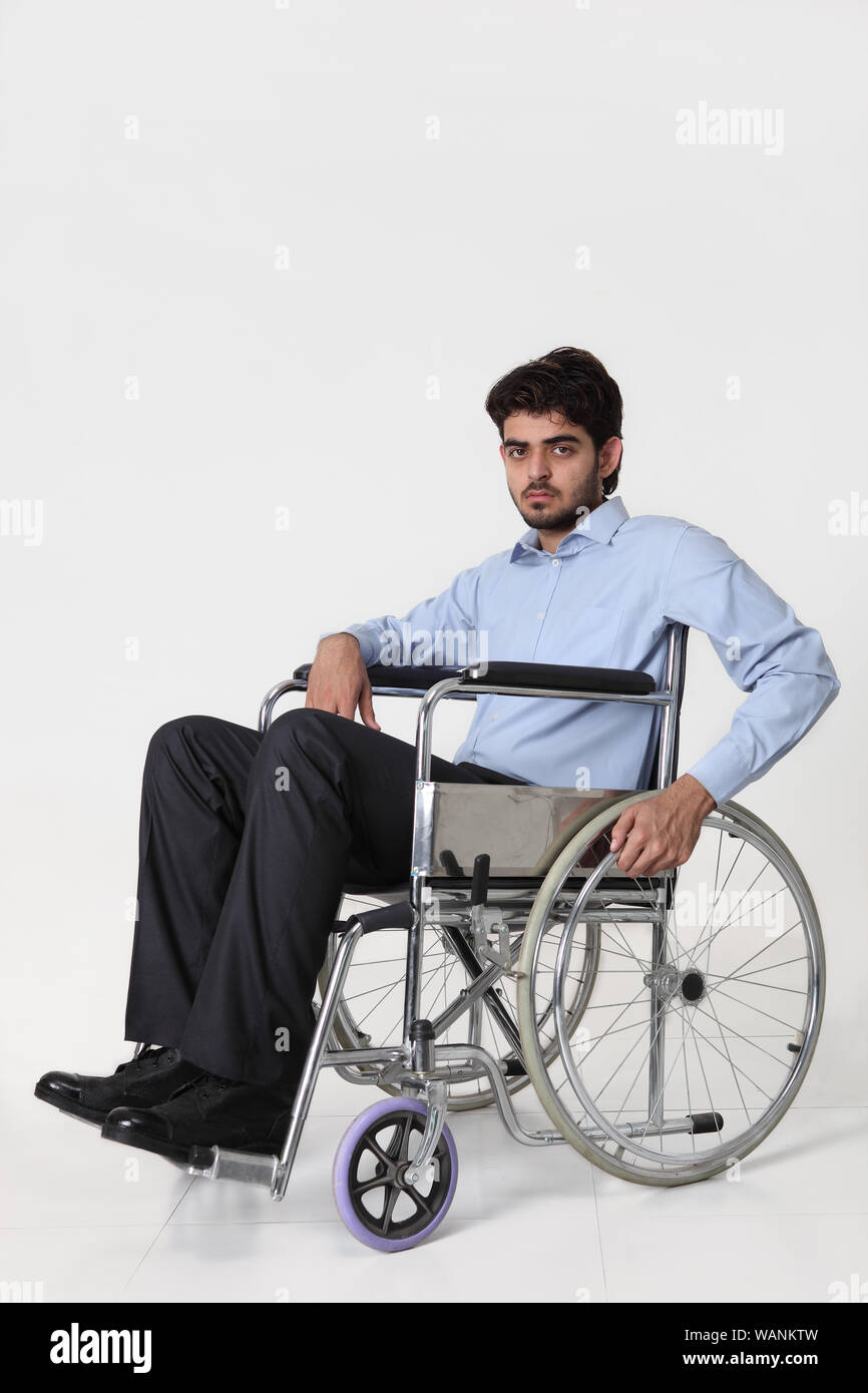 Young man sitting in a wheelchair Stock Photo - Alamy