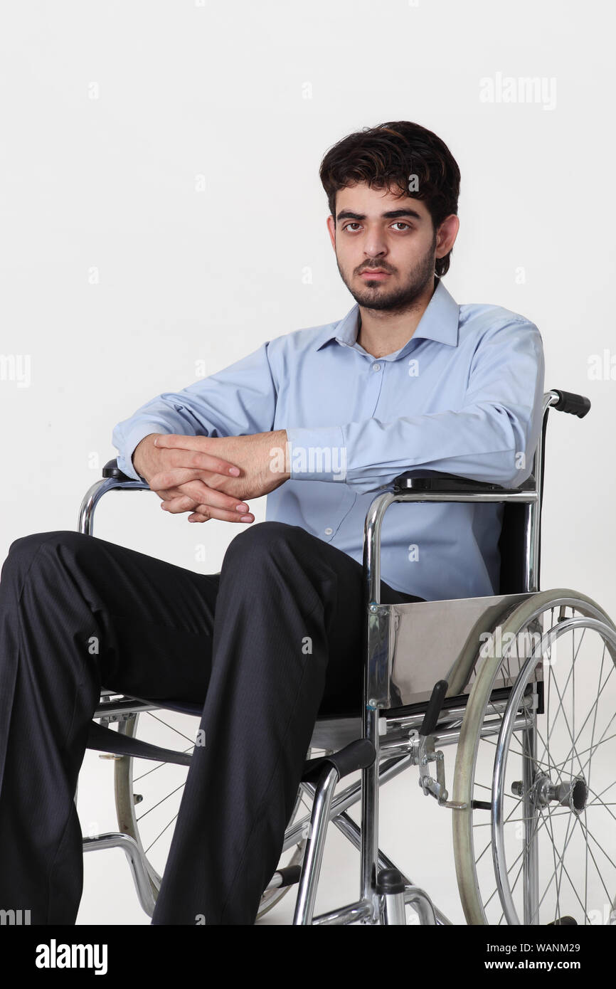 Young man sitting in a wheelchair Stock Photo - Alamy