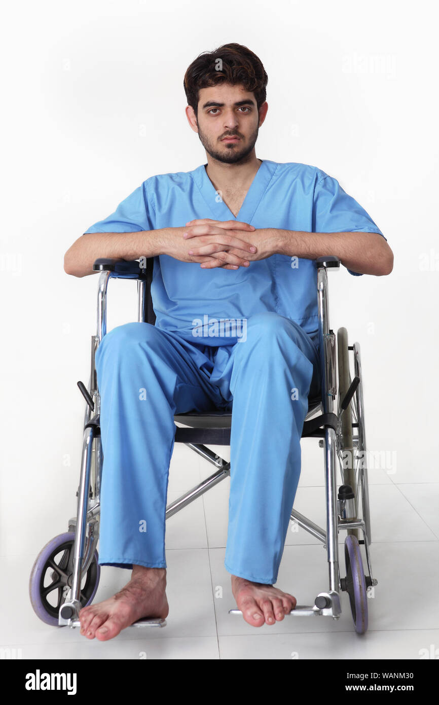 Young man sitting in a wheelchair Stock Photo - Alamy