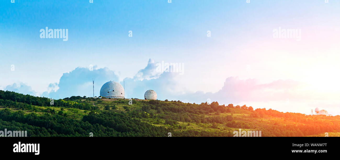 Military coastal radar stations on the mountain. Against the background ...