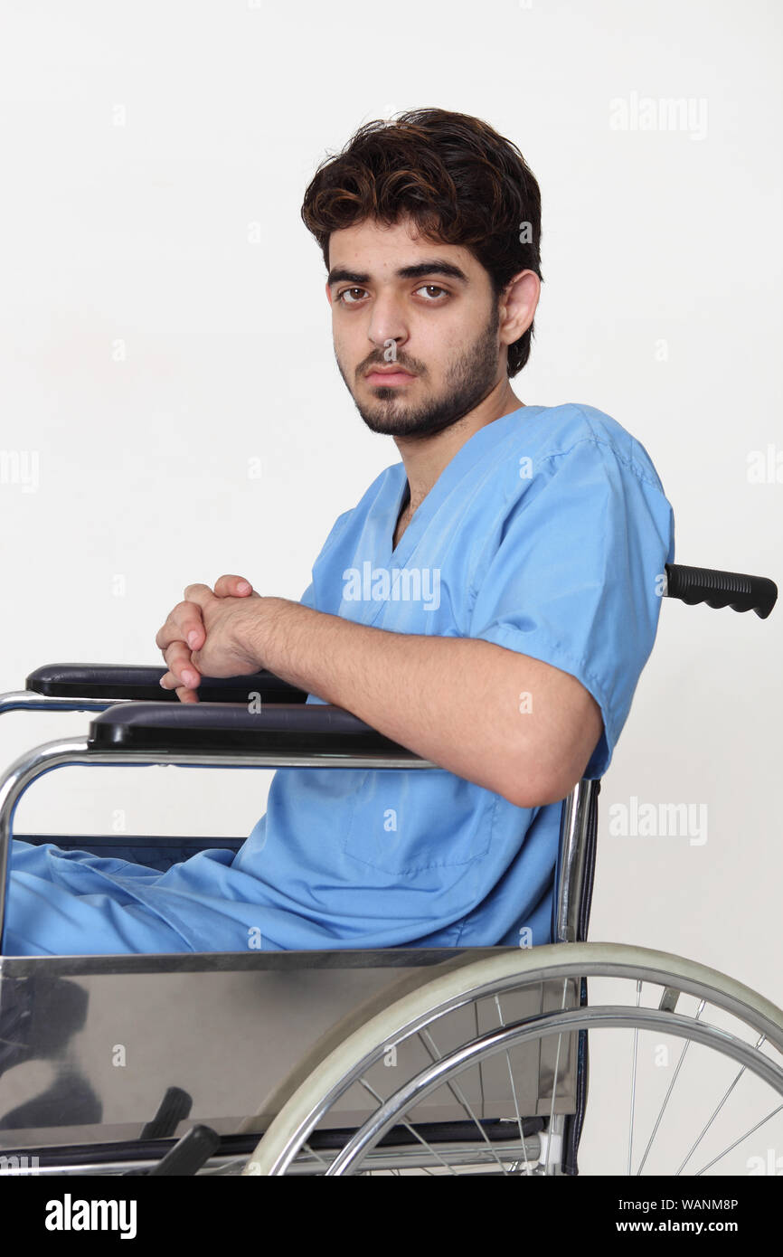 Young man sitting in a wheelchair Stock Photo - Alamy