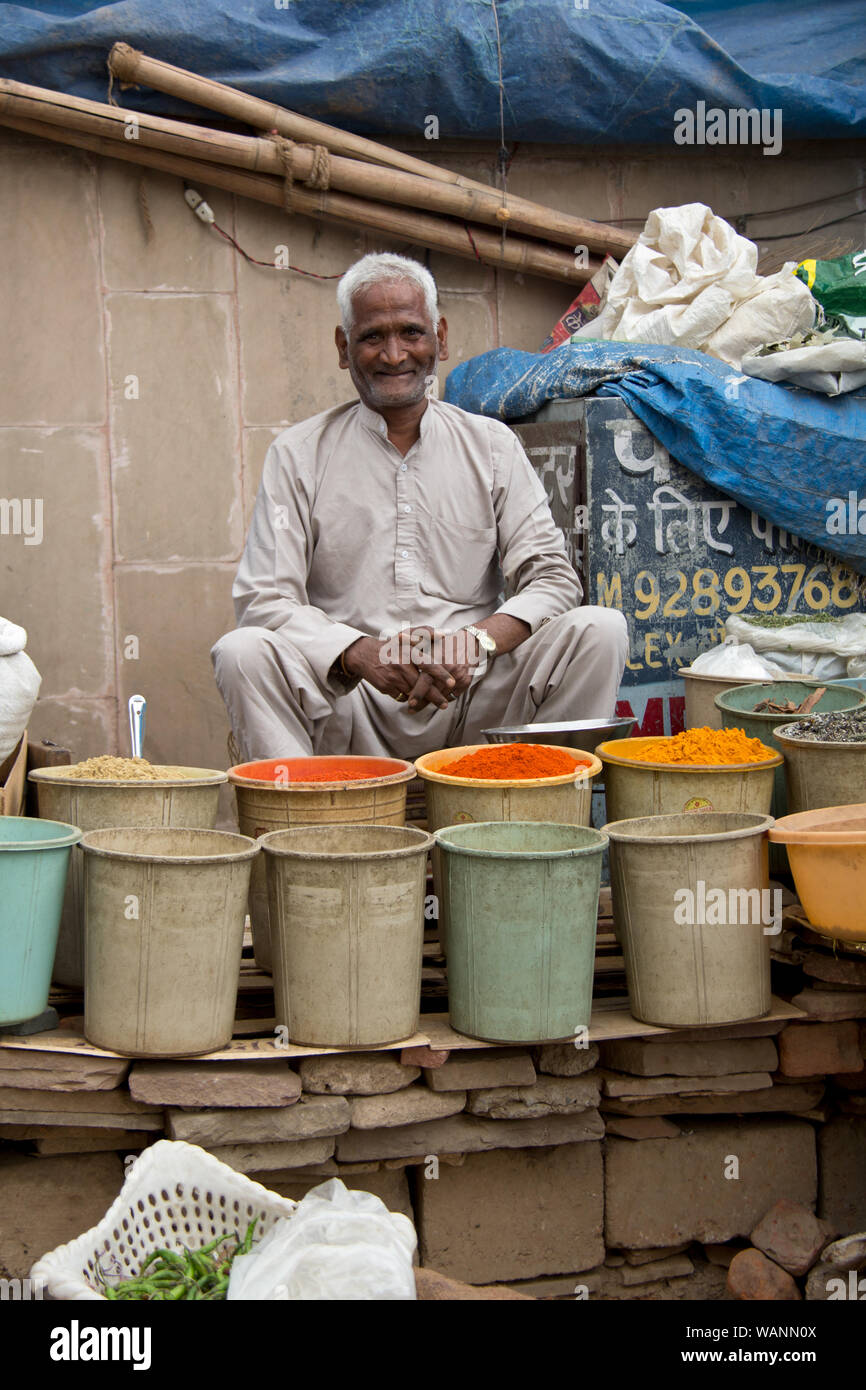 Old man selling assorted spices at a market stall, Gurgaon, Haryana ...