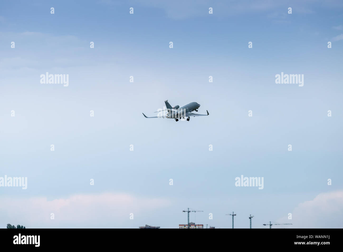 Small private business jet taking off from the city airport Stock Photo ...