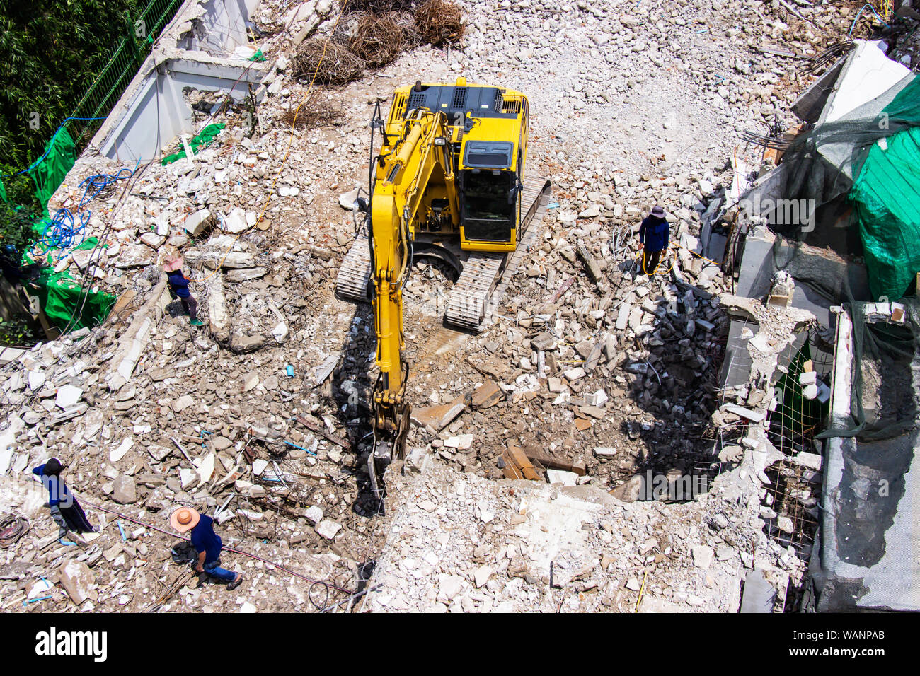 The backhoe machinery working on site demolition of an old building ...