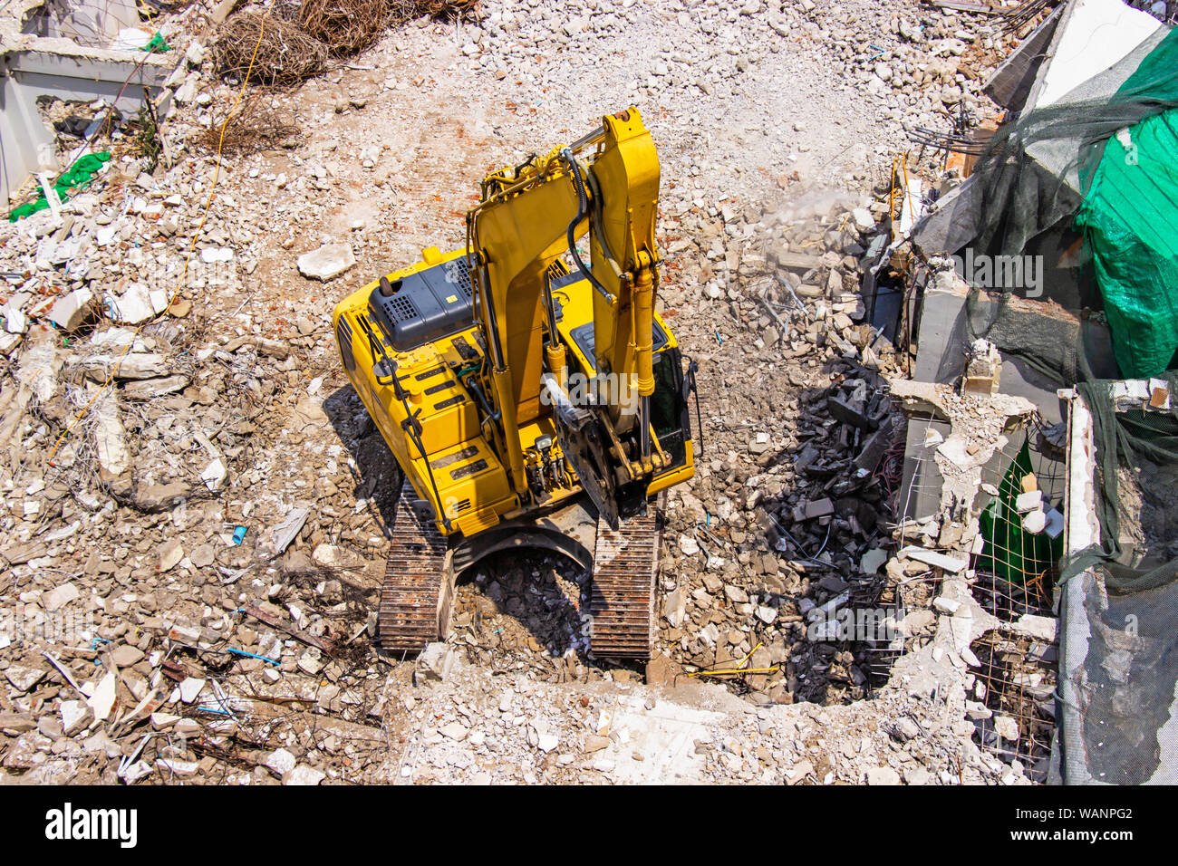 The backhoe machinery working on site demolition of an old building ...