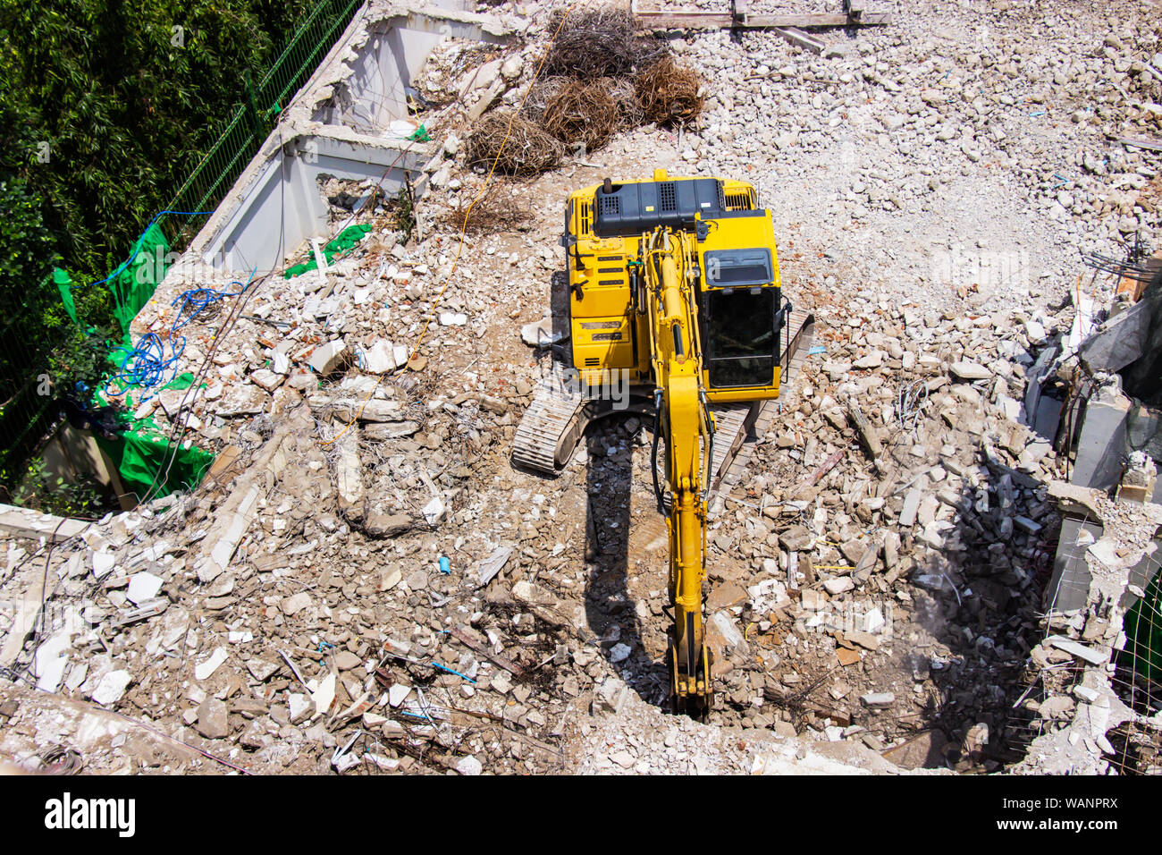 The backhoe machinery working on site demolition of an old building ...