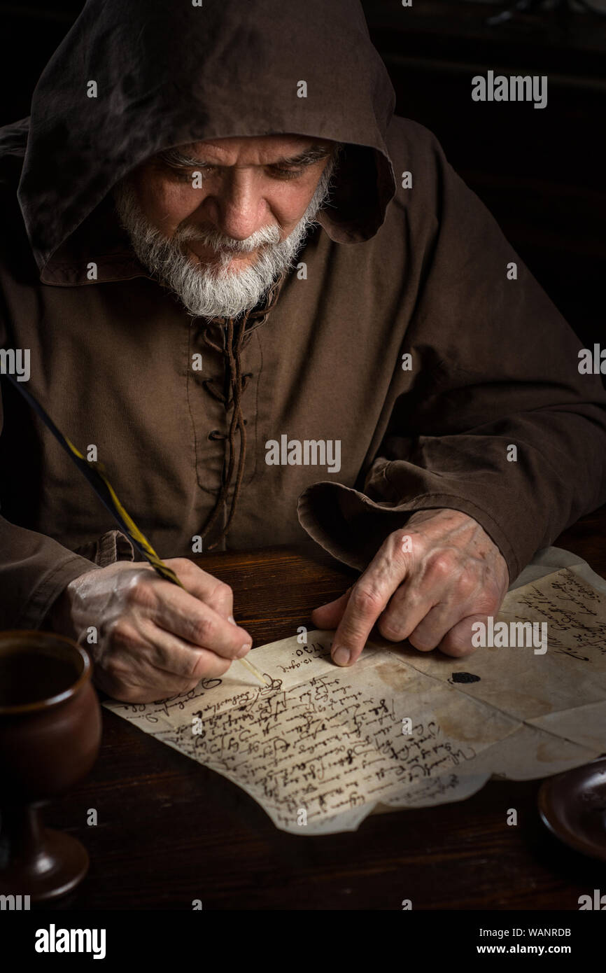 Monk in middle age with letter Stock Photo - Alamy